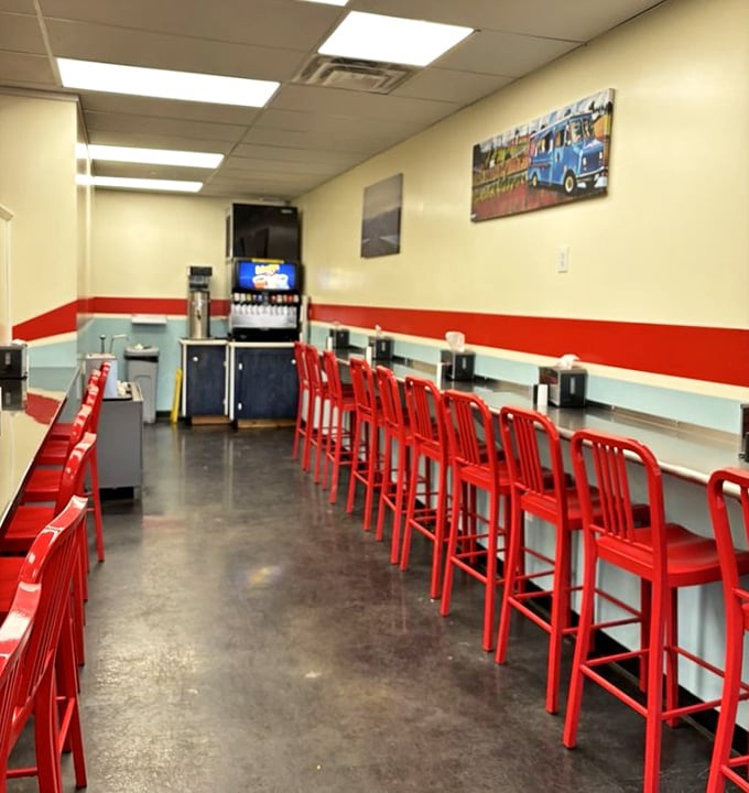 Red stools lined up like loyal soldiers, ready for the daily burger battle. Simple, clean, and focused on what matters most.