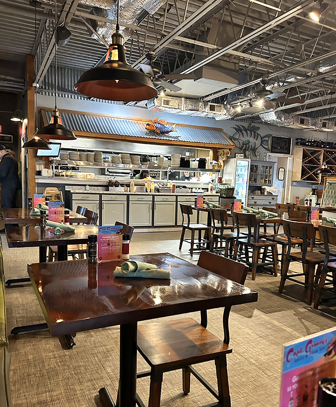 Industrial pendant lights hang over wooden tables where culinary magic happens. The exposed ceiling beams add character that chain restaurants would pay consultants to replicate.