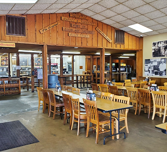 Wooden signs proclaim "Home of Elgin Hot Sausage" above simple tables where countless barbecue dreams have come true for generations of Texans.