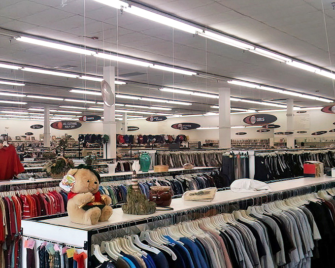 Endless racks stretch toward fluorescent horizons. In this sea of secondhand possibilities, your next fashion statement is patiently waiting to be discovered.