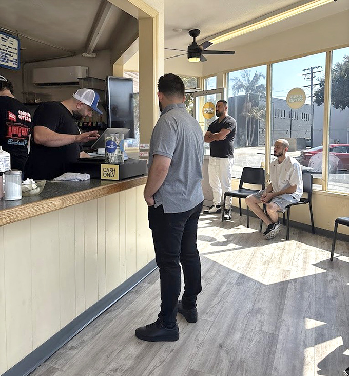 Classic wooden chairs, warm lighting, and walls adorned with memorabilia create that authentic diner atmosphere where conversations flow as freely as the coffee.