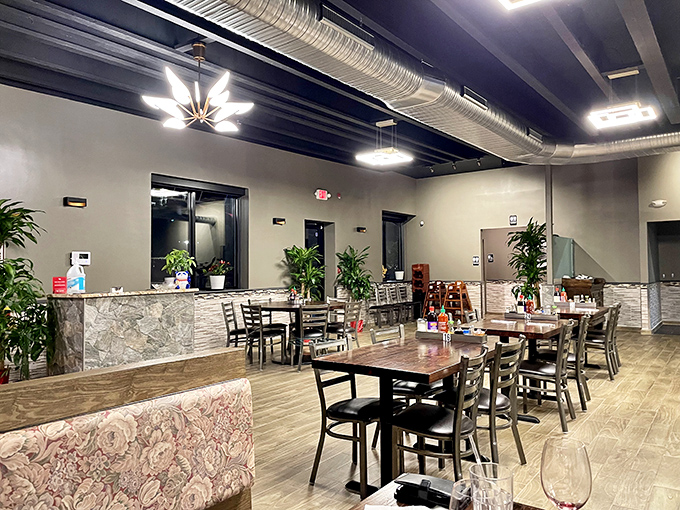 Modern meets cozy in this thoughtfully designed dining room. The exposed ductwork and warm wood tones create an atmosphere where comfort food finds its perfect home.