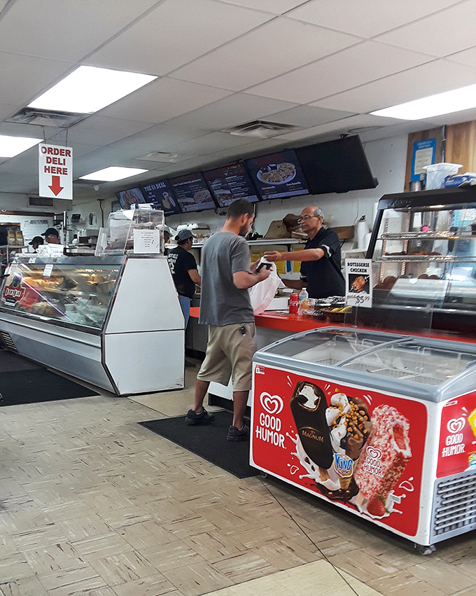 Where the magic happens! The deli counter's "ORDER HERE" sign might as well read "HAPPINESS SERVED DAILY" for Tampa sandwich aficionados.