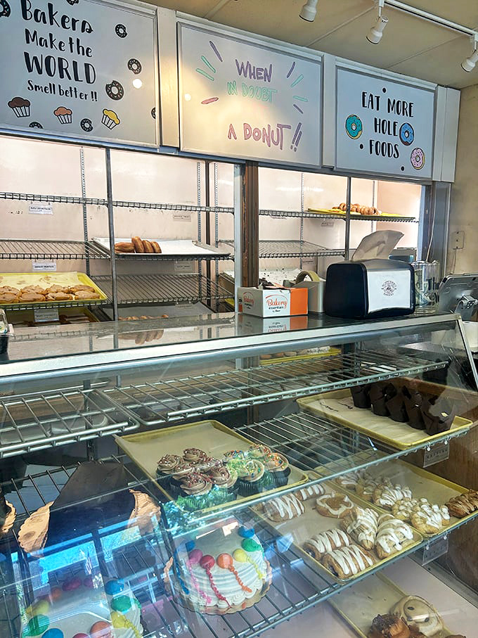 When in doubt, a donut! proclaims the whimsical sign above nearly empty shelves – clear evidence that the early bird gets the fritter in this establishment.