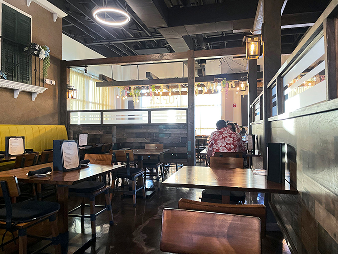 Exposed wooden beams and warm lighting transform this dining room into a mountain retreat where conversations flow as smoothly as the wine.