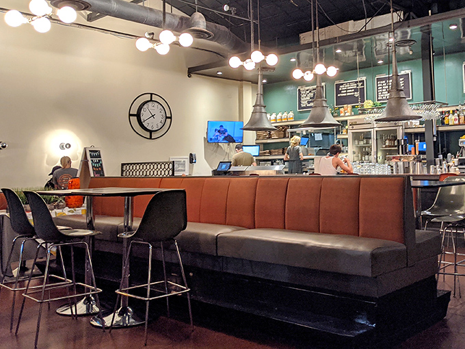 Modern diner perfection: sleek leather booths, industrial lighting, and that open kitchen where culinary magic happens while you sip your coffee.
