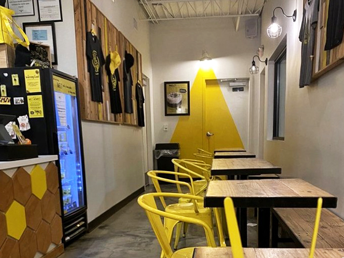 Yellow chairs and honeycomb walls create a cheerful hive where sweet dreams come true one scoop at a time.