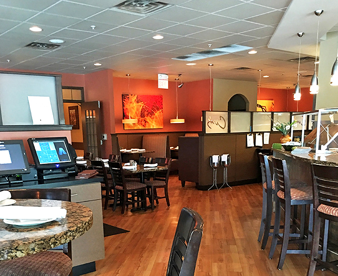 The warm terracotta walls and wooden accents create that "Nonna's dining room" vibe&mdash;minus the plastic-covered furniture and cheek pinching.