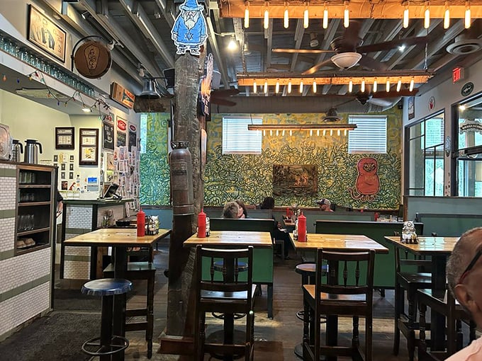 Edison bulbs cast a warm glow over the eclectic interior where vintage signs meet colorful folk art. It's like dining inside a museum that serves comfort food.