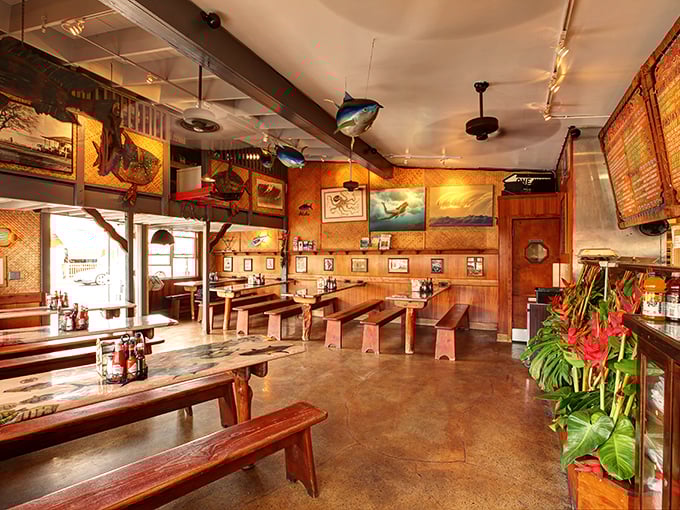 Wooden communal tables and fish-themed decor create the perfect backdrop for the seafood drama about to unfold on your plate.