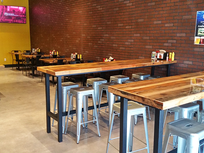 Industrial-chic meets comfort in this thoughtfully designed space. Wooden communal tables and metal stools create the perfect backdrop for serious food enjoyment.