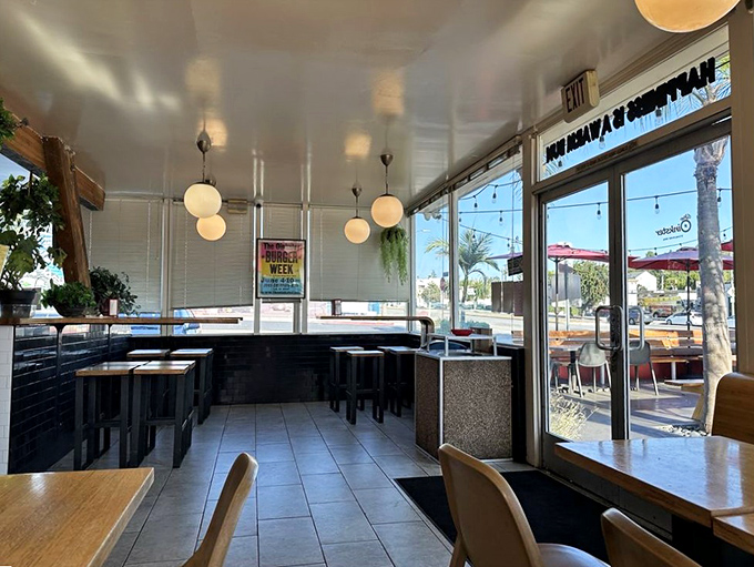 Clean lines, globe lights, and minimalist design&mdash;proof that The Oinkster knows great food needs no distractions, just comfortable seats and good company.