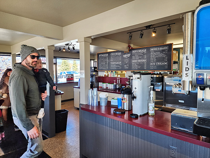 Where burger magic happens! The counter service setup keeps things moving while the menu board tempts with possibilities beyond your wildest cravings.
