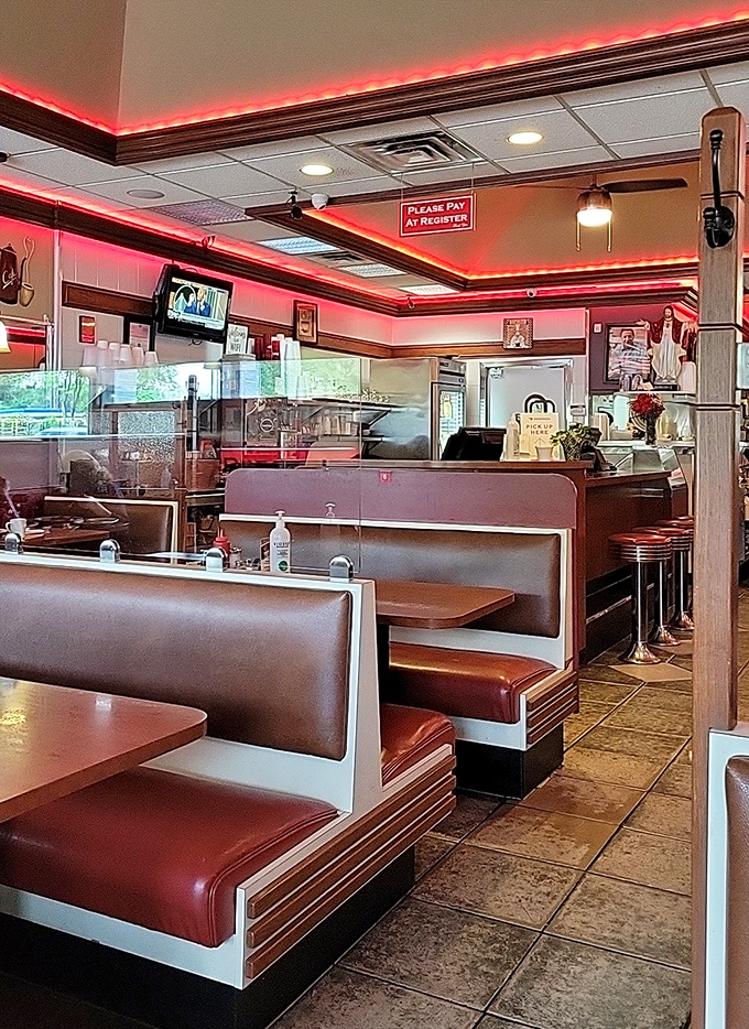 Wooden tables, green vinyl chairs, and rooster decor create that perfect "come as you are" atmosphere where breakfast dreams become reality.