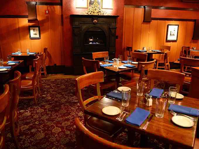 The heart of Orso: wooden tables bathed in amber light, a crackling fireplace, and the promise of seafood so fresh it practically introduces itself.