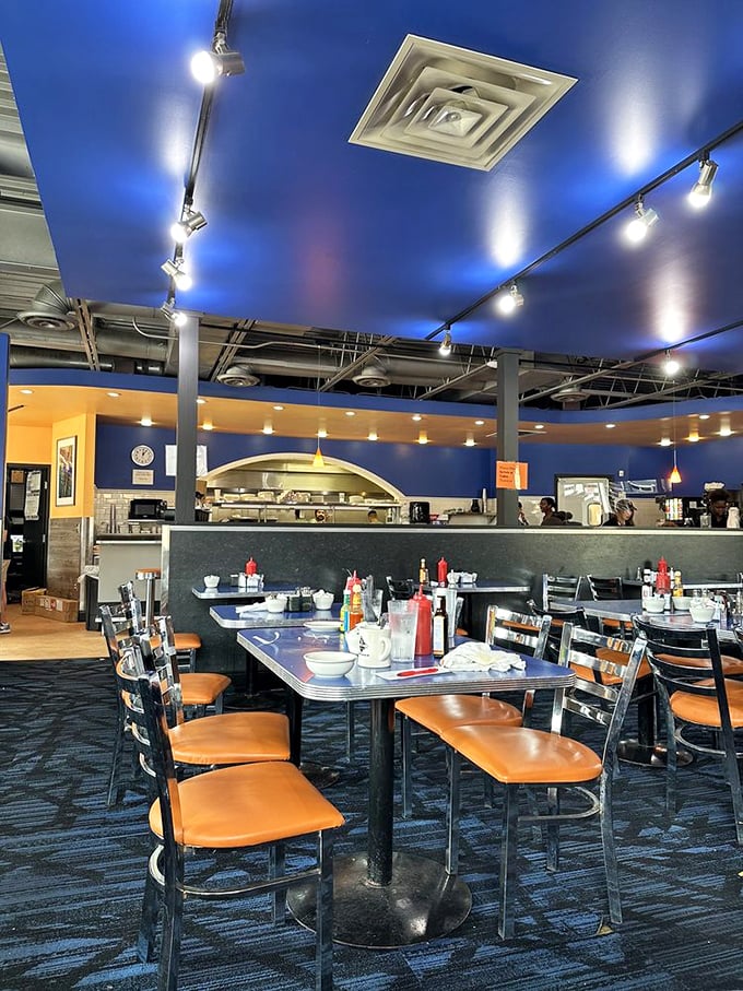 The vibrant blue ceiling creates an unexpectedly modern atmosphere. Classic diner comfort meets contemporary design in this beloved Uptown institution.