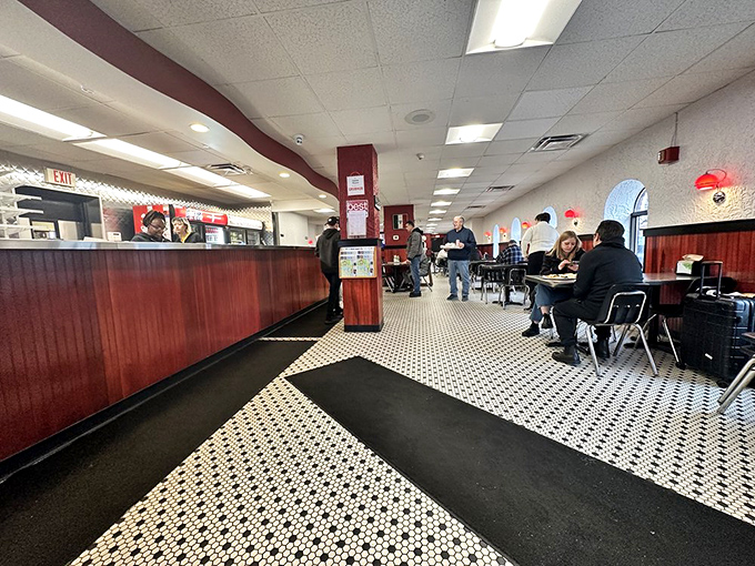 The no-frills interior with its classic black and white tile floor speaks volumes: here, it's all about the pizza, not the decor.