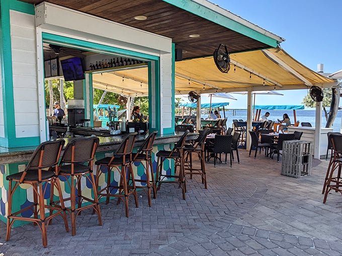 Island vibes flow as freely as the ocean breeze at this open-air bar, where turquoise accents mirror the waters just steps away.