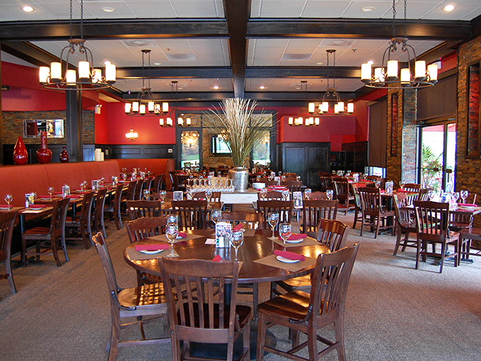 The warm red walls and wooden beams create an atmosphere that says "special occasion" while the comfortable chairs whisper "stay awhile."