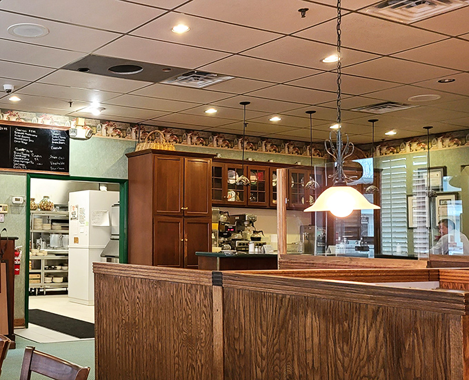 Wood paneling and pendant lights create that classic diner atmosphere where conversations flow as freely as the coffee refills.