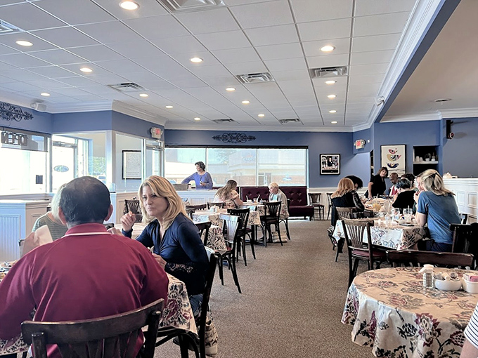 Where breakfast dreams come true. The soft blue walls and floral tablecloths create that rare atmosphere where both grandparents and hipsters feel equally at home.