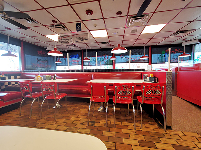 Cherry-red booths and checkerboard accents create the perfect backdrop for conversations that flow as easily as the coffee refills in this retro haven.