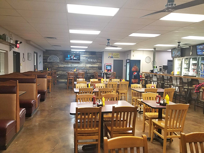 Inside, wooden tables and chairs create that perfect small-town atmosphere where conversations flow as freely as the coffee refills.