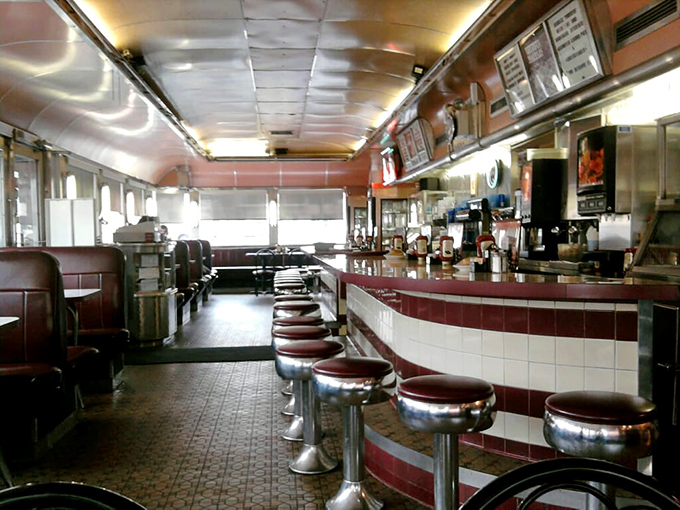 Counter seats and burgundy booths await hungry patrons, where conversations flow as freely as the bottomless coffee.