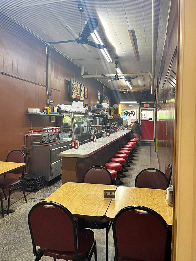 Step inside to a time capsule of American diner culture. Those red vinyl stools have supported countless satisfied customers seeking comfort food perfection.