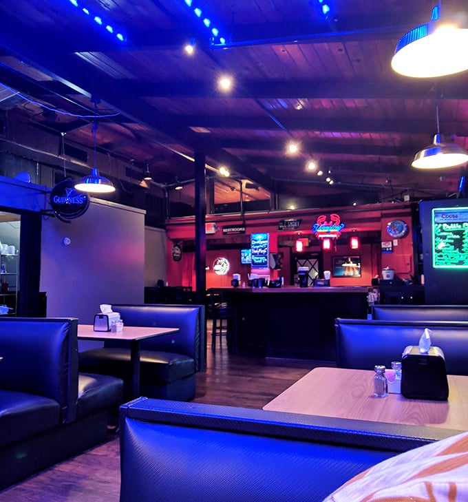 The interior's moody blue lighting creates an underwater ambiance that sets the perfect stage for seafood indulgence.