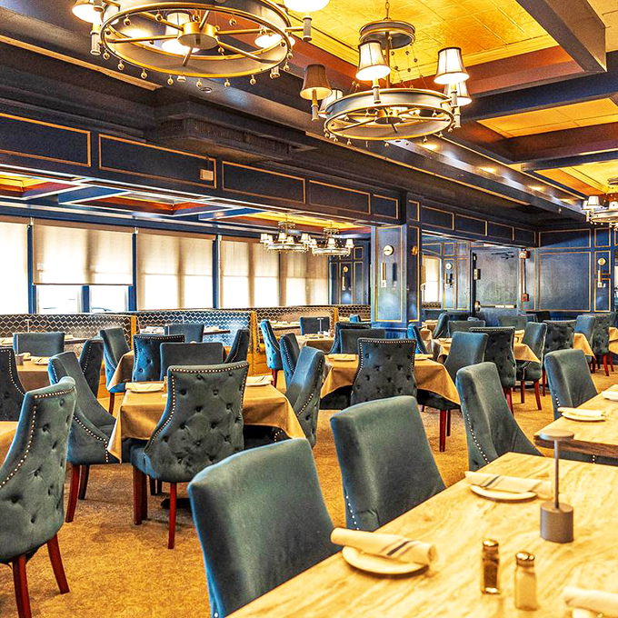 Blue velvet chairs and nautical elegance create an atmosphere that says "yes, you can wear flip-flops, but you might want to consider upgrading to boat shoes."