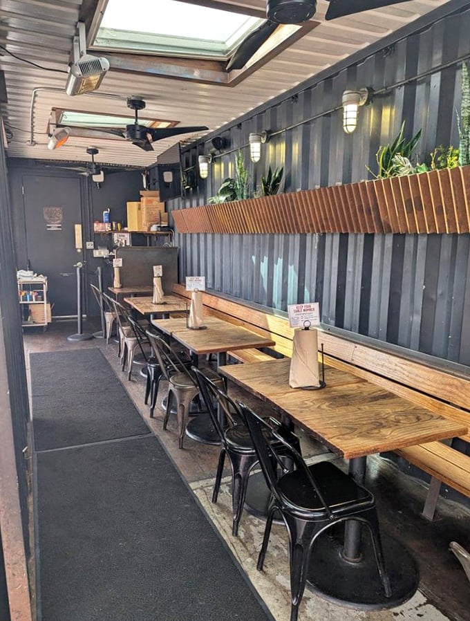 Wine bottles create a luminous backdrop in this cozy corner, where seafood dreams and Chardonnay realities beautifully collide.