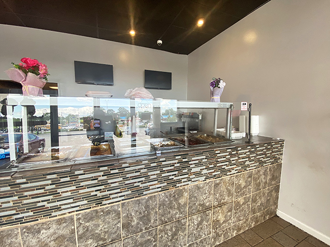 Behind this modest counter, culinary magic happens daily. It's like watching a championship team warm up before they deliver the flavor equivalent of a slam dunk.