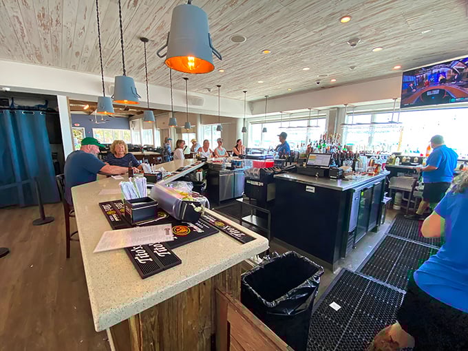 The bar buzzes with anticipation as patrons gather for libations and seafood celebrations. Those pendant lights aren't the only things glowing.