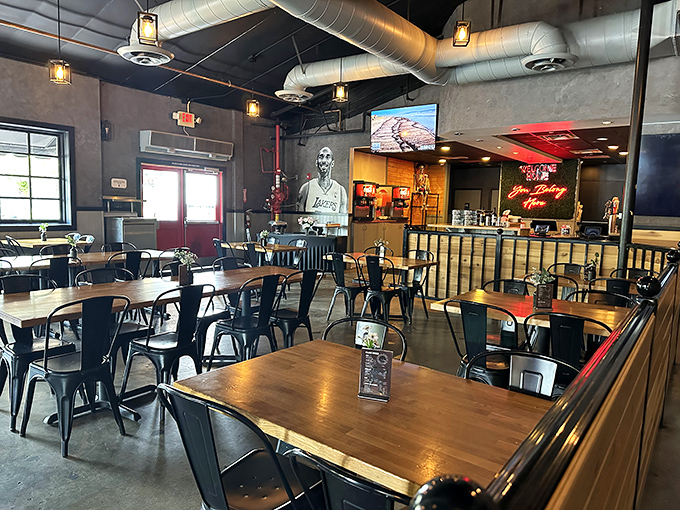 Industrial chic meets barbecue comfort in a space where Lakers murals and exposed ductwork create the perfect backdrop for serious meat appreciation.