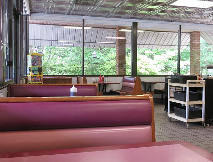 Classic burgundy booths invite you to slide in and stay awhile. The view outside is just a bonus to the culinary journey waiting inside.