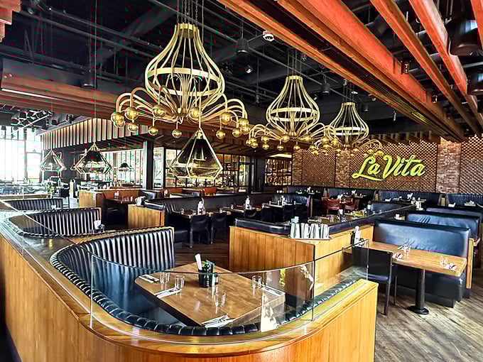 Those golden chandeliers aren't just lighting fixtures&mdash;they're conversation starters hanging above curved booths designed for lingering dinners and endless stories.