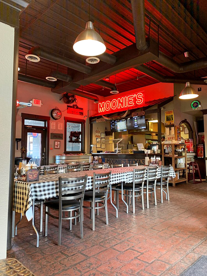 Red-tinged lighting bathes the checkered tablecloths in a warm glow, as if the restaurant itself is blushing from all the compliments.