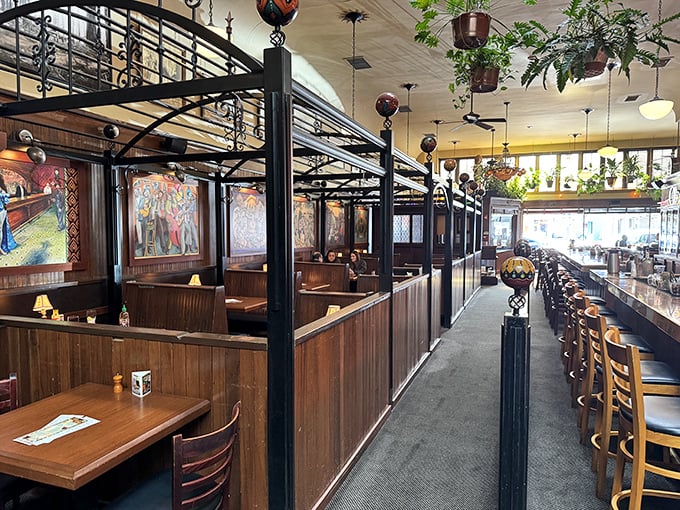 Wooden booths with wrought iron accents create little sanctuaries for dining. Like sitting in your own private railway car from a more civilized era.