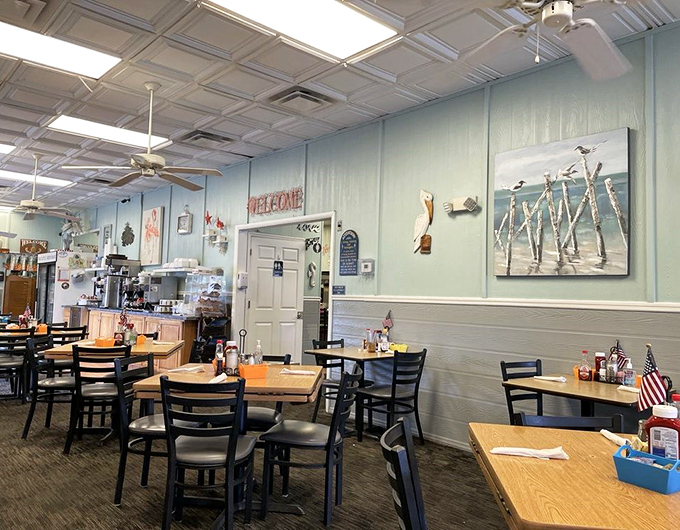 Coastal blues, pelican art, and a big "WELCOME" sign—this isn't interior decorating, it's a warm Florida hug in restaurant form.