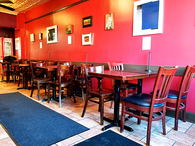 Warm red walls and wooden tables create an unpretentious dining space where the food, not the decor, rightfully takes center stage.