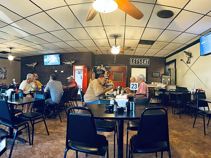 Inside, the "LETSEAT" sign isn't just decoration&mdash;it's practically the town motto. Simple tables, ceiling fans, and conversations that flow as freely as the coffee.