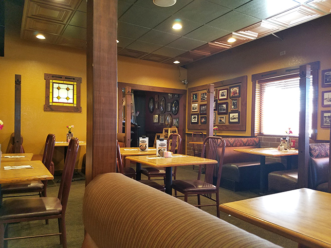 Warm yellow walls, wooden booths, and decades of framed memories create the perfect atmosphere for savoring a legendary Denver steak.