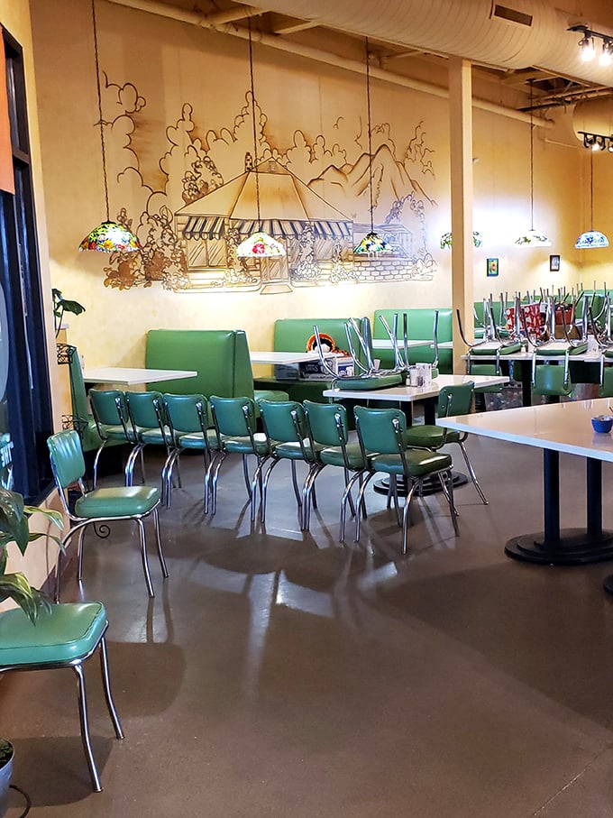 Retro mint-green chairs and whimsical wall art create the perfect backdrop for morning magic. Breakfast with a side of nostalgia.