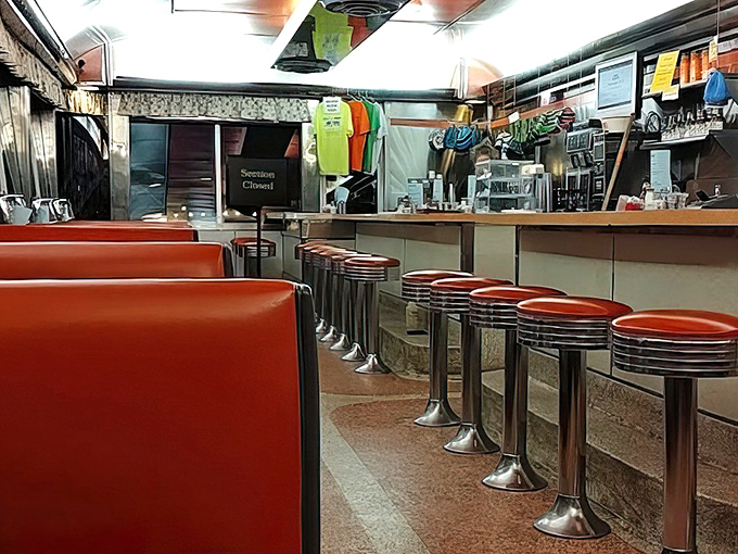 Red vinyl booths and chrome stools &ndash; the universal language of "sit down and stay awhile." Diner perfection in every detail.