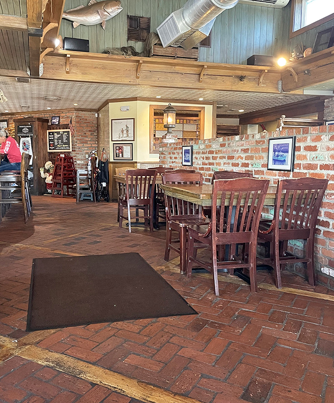 Exposed brick, weathered wood, and mounted fish create that perfect "I've discovered something authentic" atmosphere that no corporate designer could replicate.