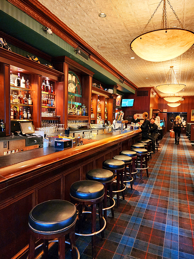 Classic elegance meets Midwestern comfort in Jax's bar area, where the plaid carpet has witnessed more celebrations than a birthday cake factory.