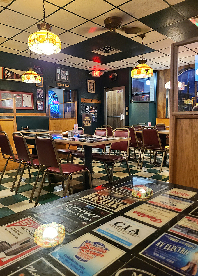 Classic Tiffany-style lamps cast a warm glow over the checkered floor &ndash; dining ambiance that's remained deliciously unchanged for decades.