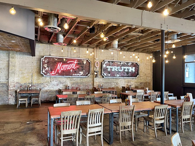 Edison bulbs illuminate exposed brick walls adorned with vintage-style "Moment" and "Truth" signs&mdash;a dining room that feels both timeless and Instagram-ready.