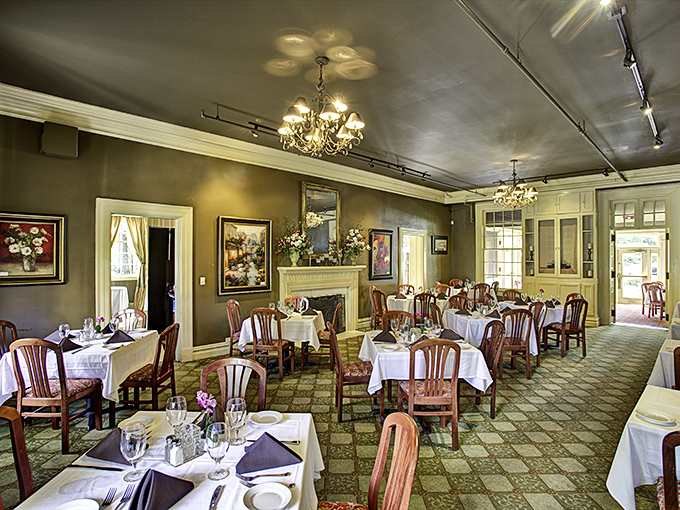 Elegant chandeliers cast a golden glow over white tablecloths, creating the perfect backdrop for food that deserves its own spotlight.